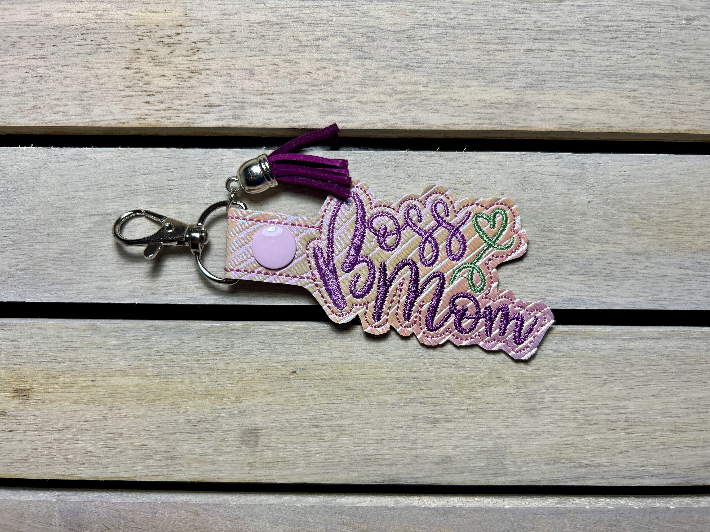 Embroidered leather key fob with bee design.